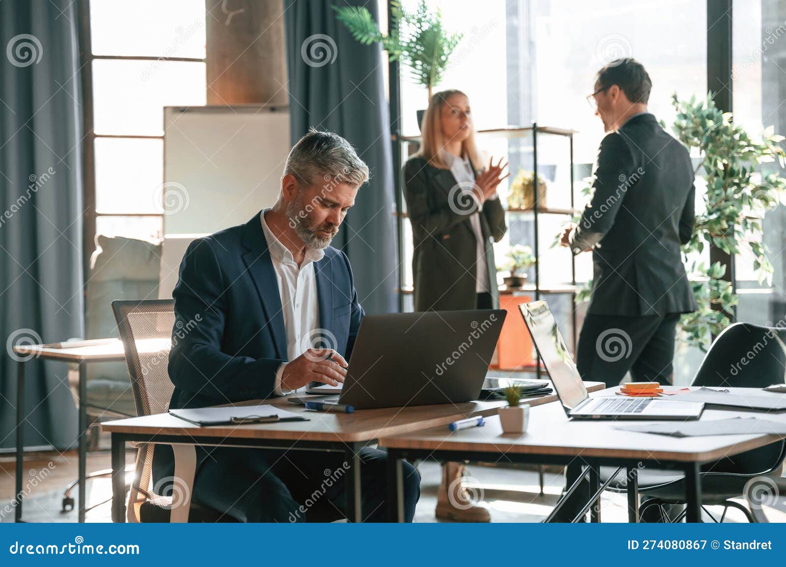 Three People are Busy in the Office. Group of Employees are Working ...