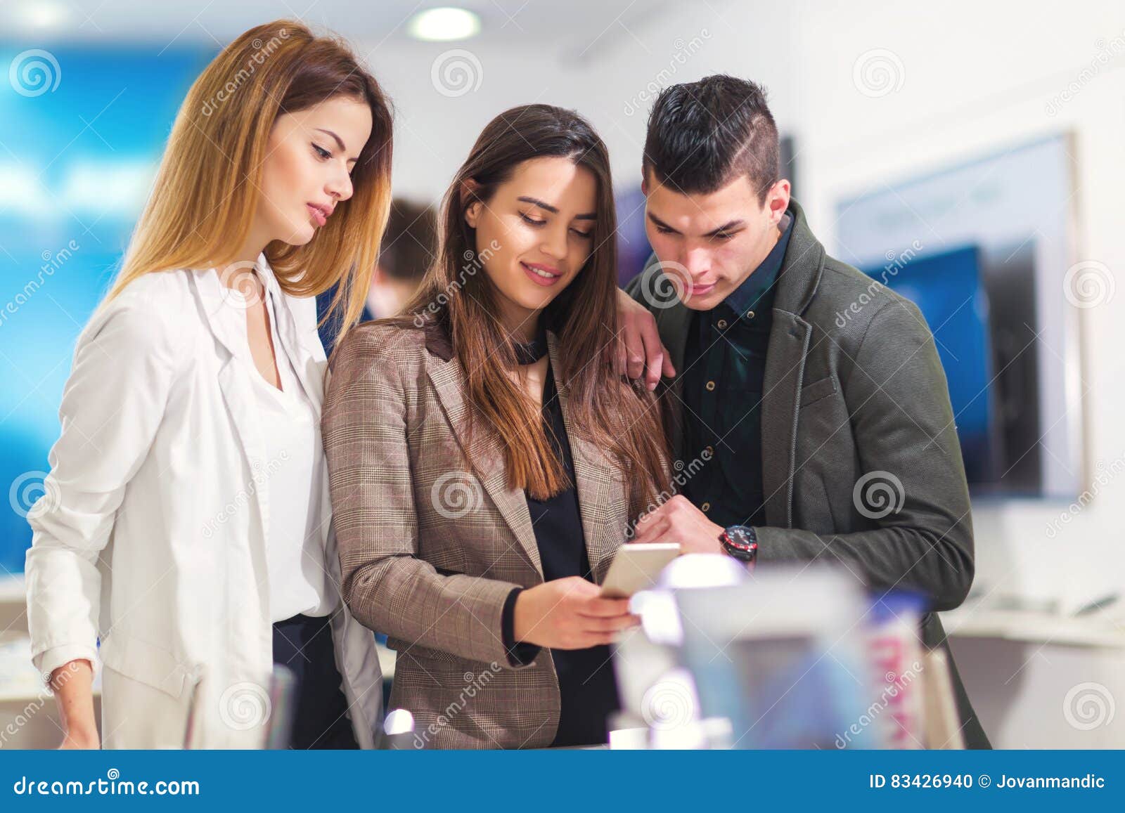 Three People are Choosing Smart Phones Stock Photo - Image of depth ...