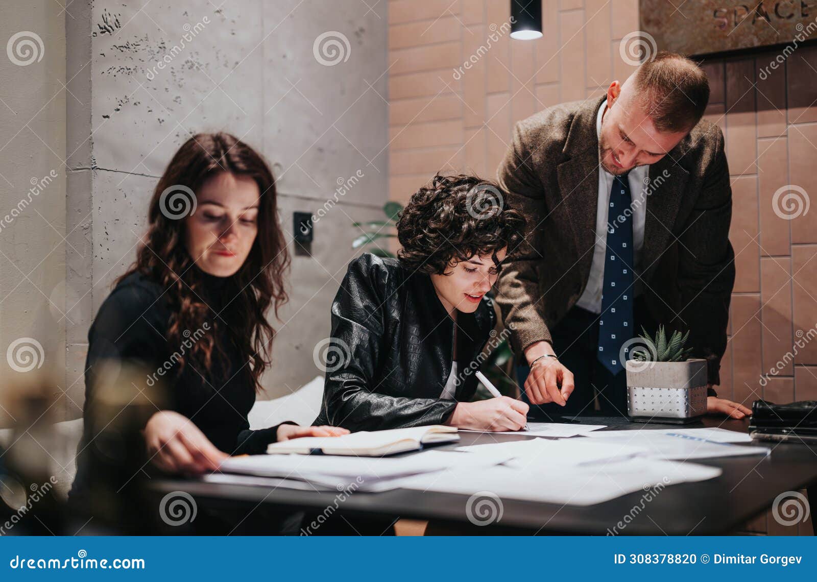 Three People Collaborate on Project in a Modern Office Space, Engaging ...