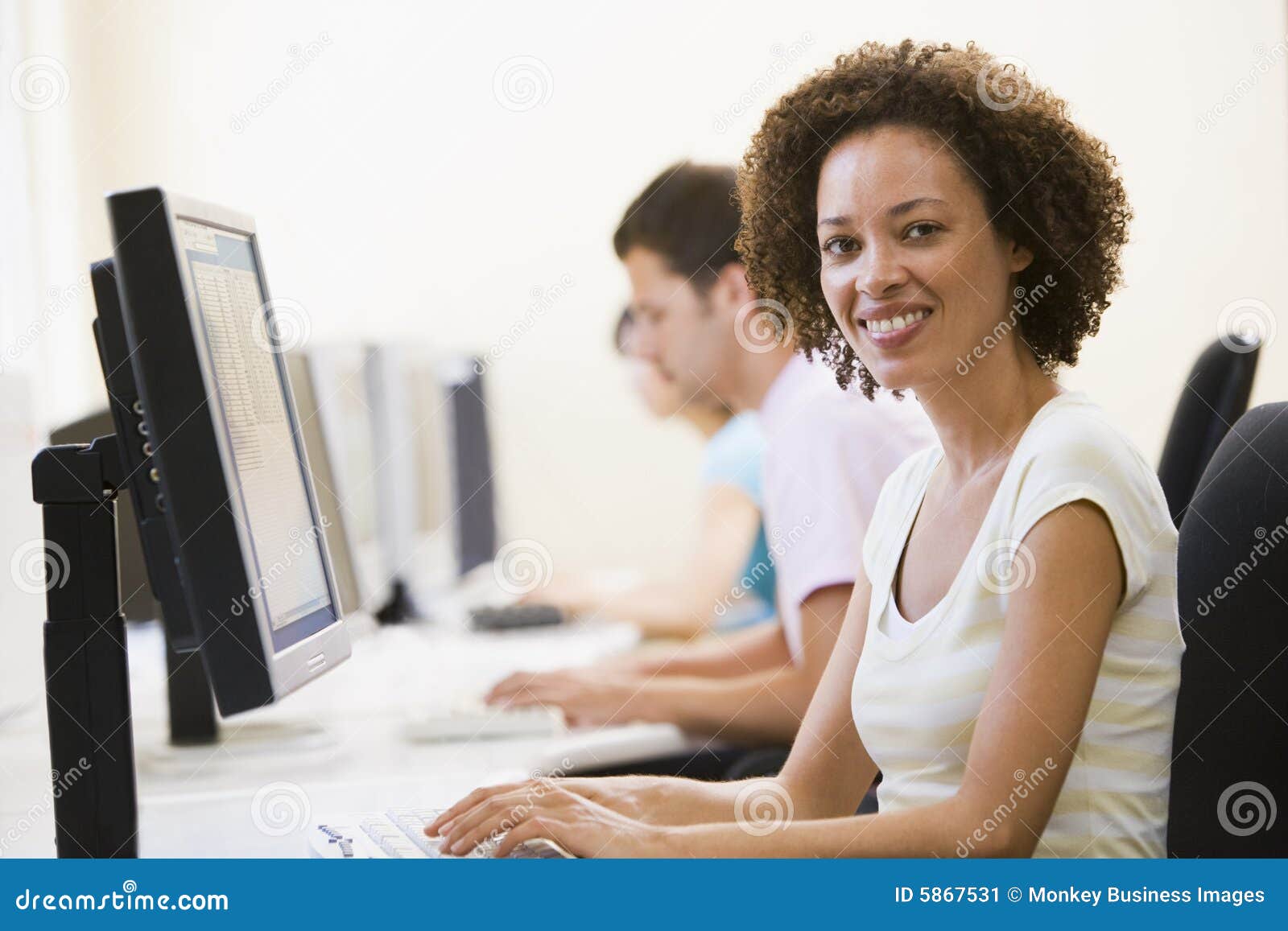 Three People in Computer Room Typing and Smiling Stock Image - Image of ...