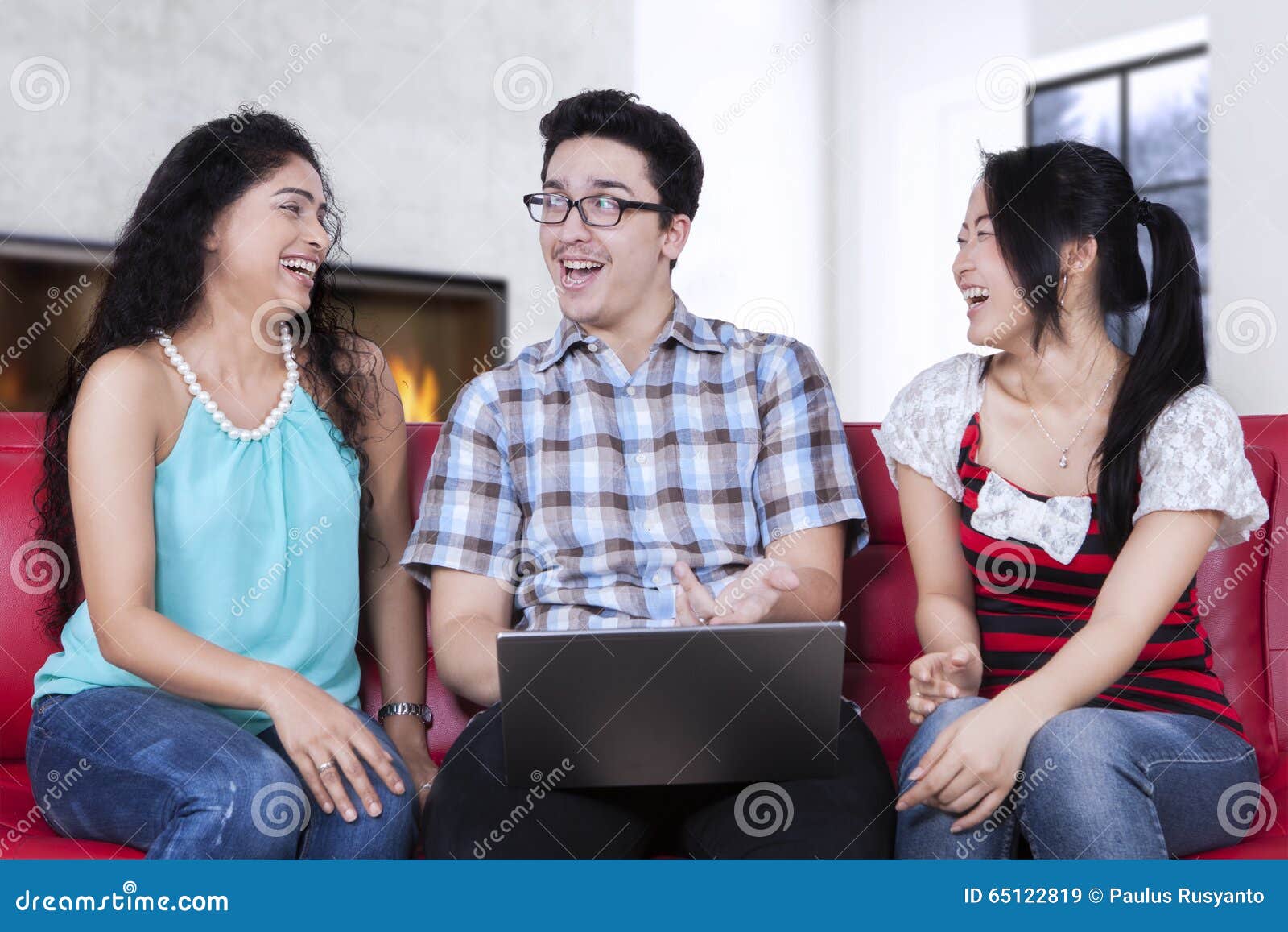 Three People Discussing on Sofa while Using Laptop Stock Image - Image ...