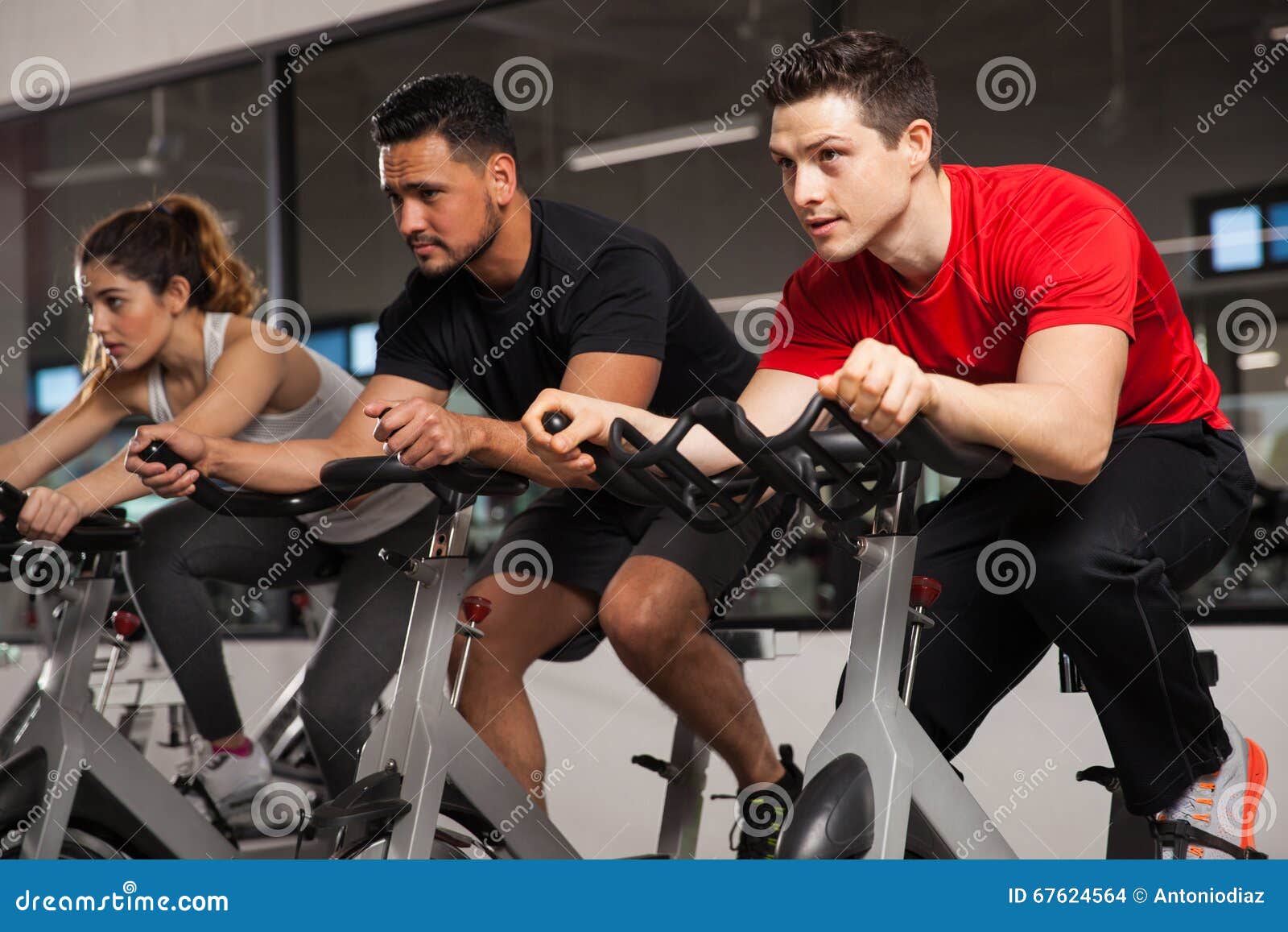 Three People Doing Cardio on a Bicycle Stock Photo - Image of active ...