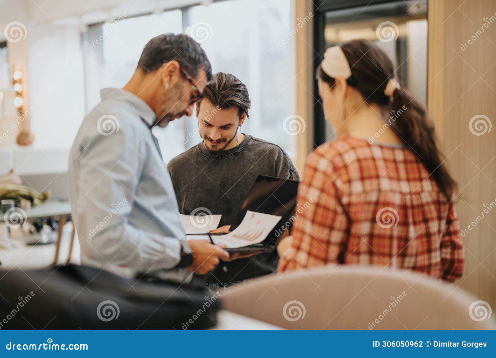 Multi Generational, Business Colleagues Collaborating on Project in ...