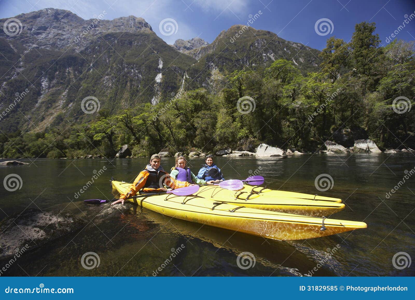 Three People Kayaking in Mountain Lake Stock Image - Image of fordland ...