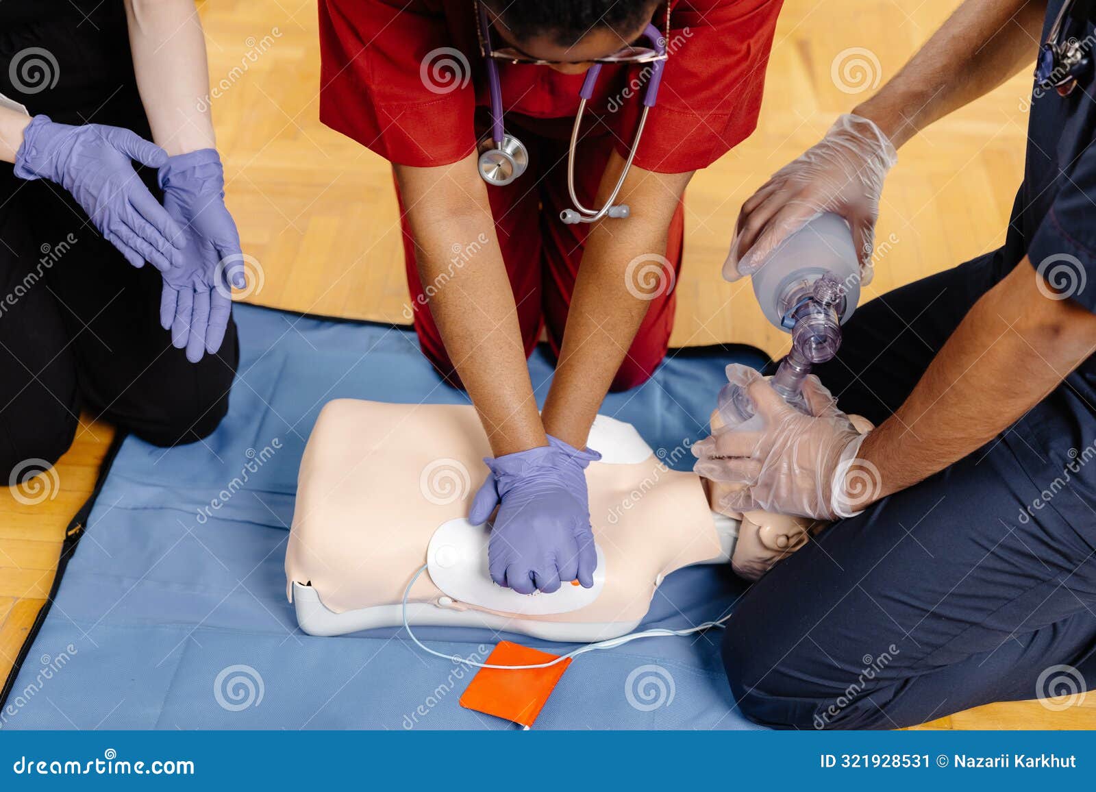 Three People are Practicing CPR on a Training Mannequin. Stock Image ...