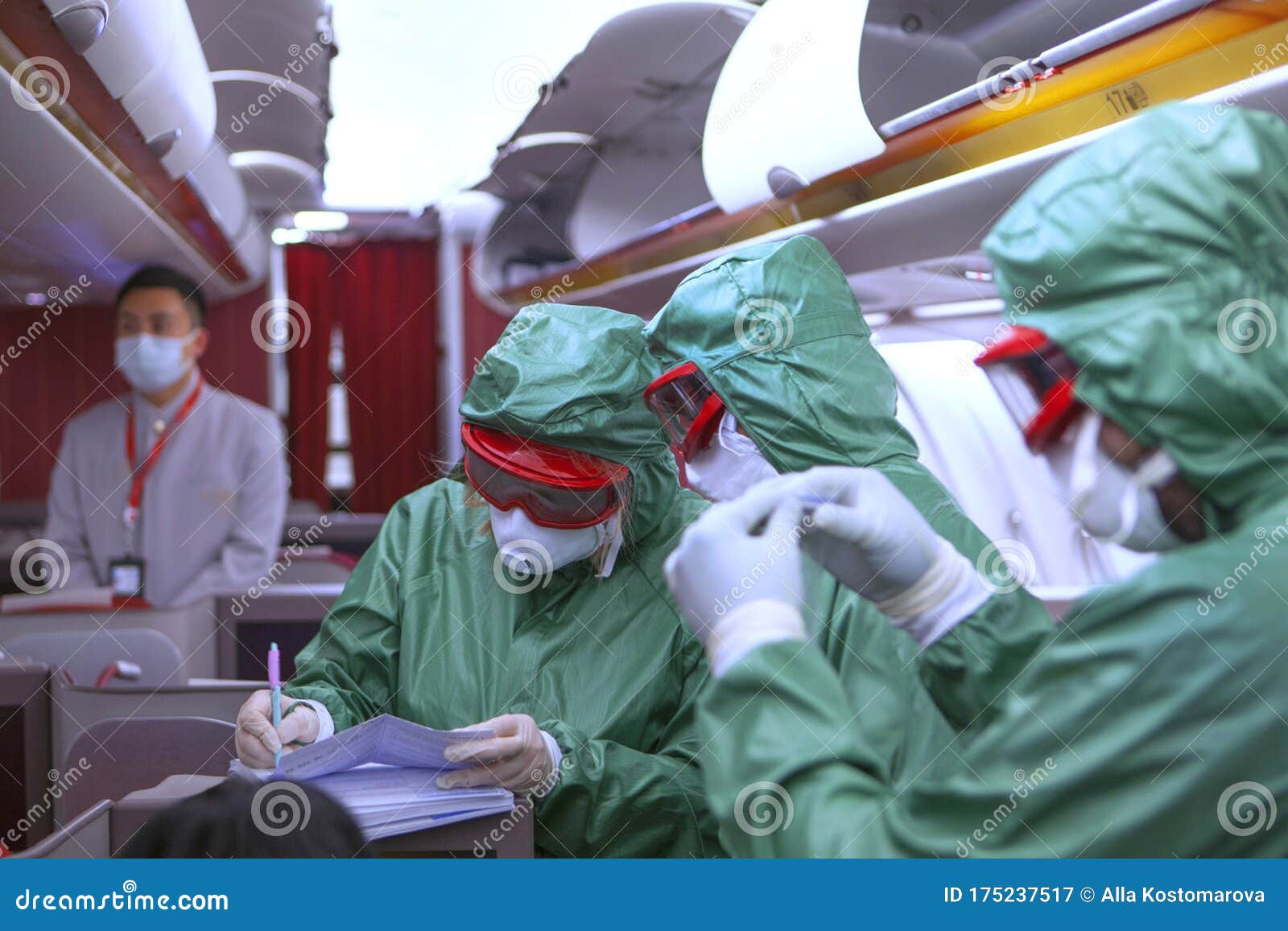 Three People in Protective Clothing from Viruses and Microbes Work on ...