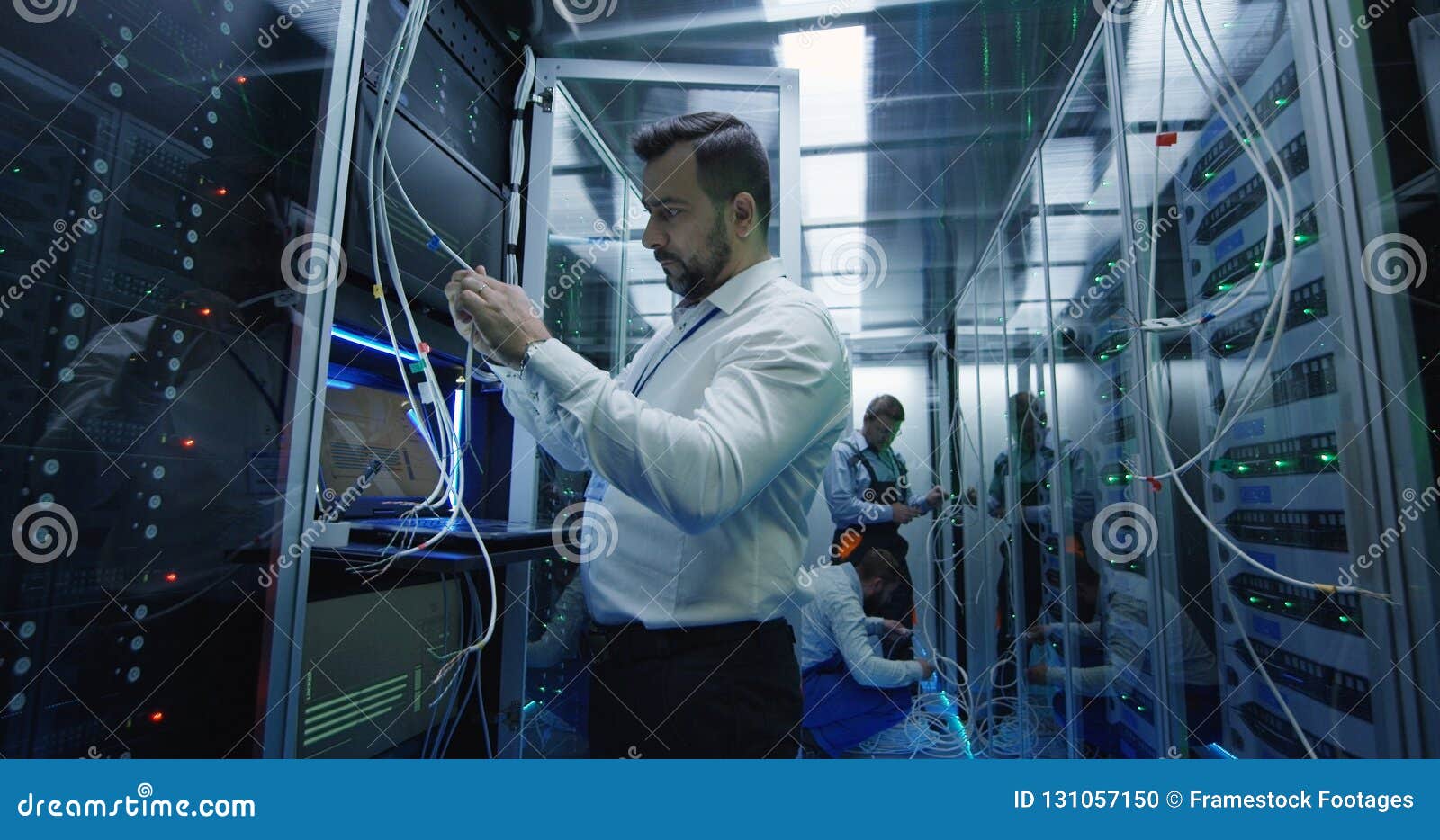Three People Working in a Data Center with Cable Stock Photo - Image of ...