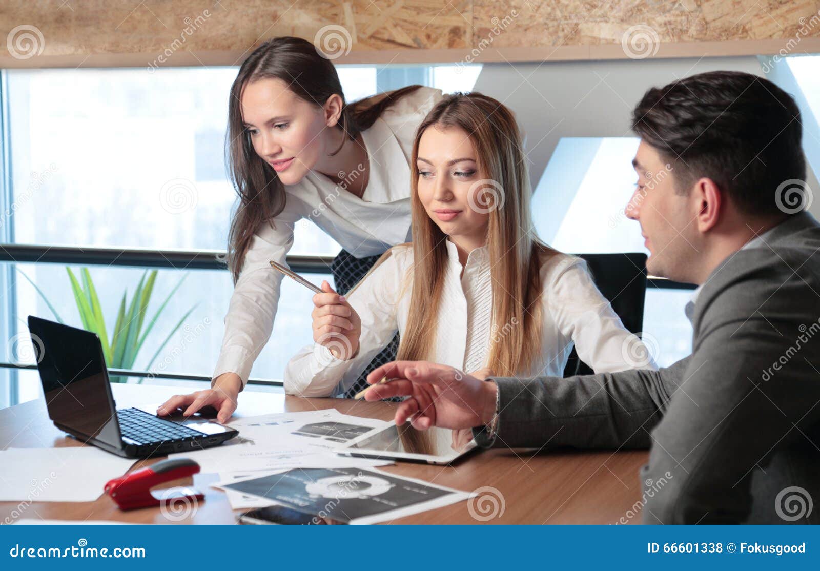 Three People Working at Netbook Stock Photo - Image of papers ...