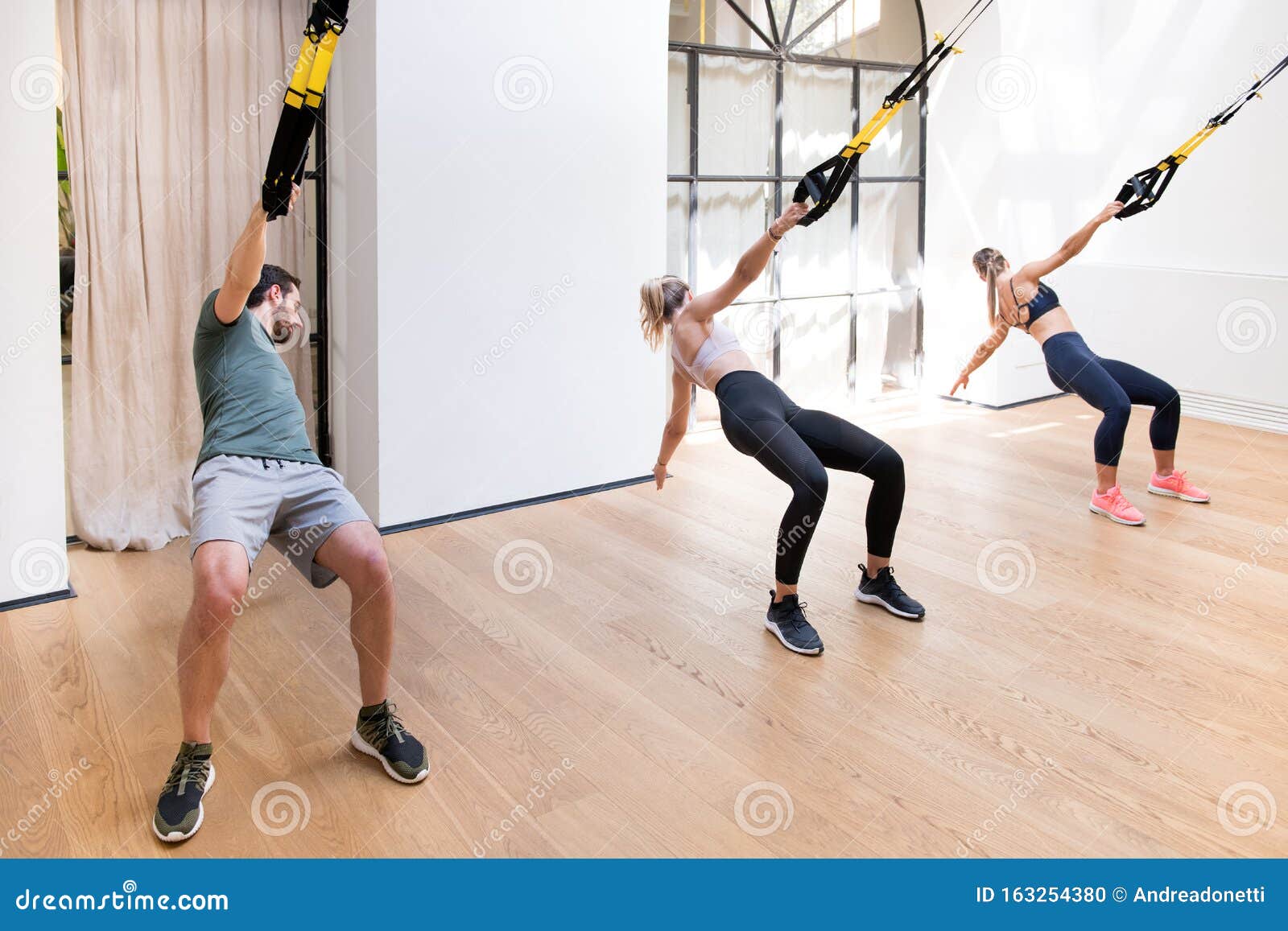 Three People Working Out Doing Trx Power Pulls Stock Photo - Image of ...