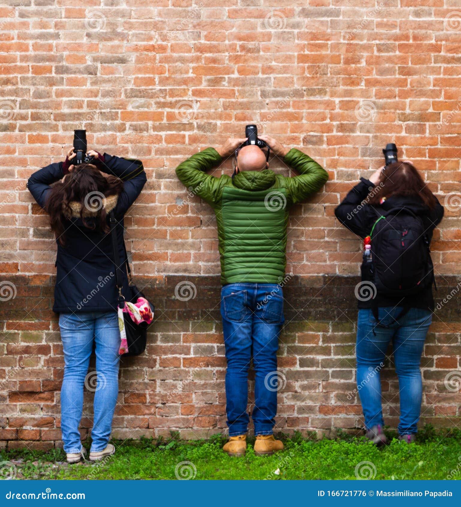Three Photographers Shooting Upwards Leaning Against the Wall Editorial ...