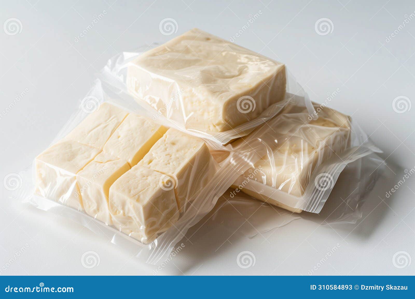 Three Pieces of Cheese Wrapped in Plastic on White Surface Stock Image ...