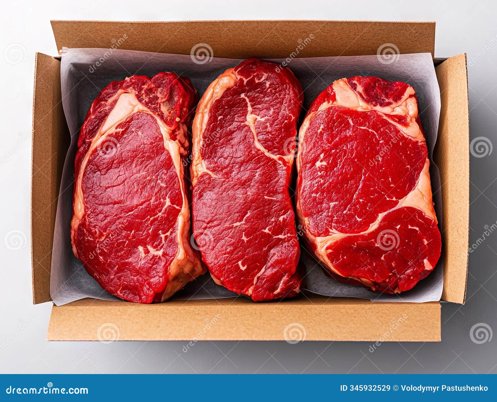 Three Pieces of Meat in a Cardboard Box on a Table Stock Image - Image ...