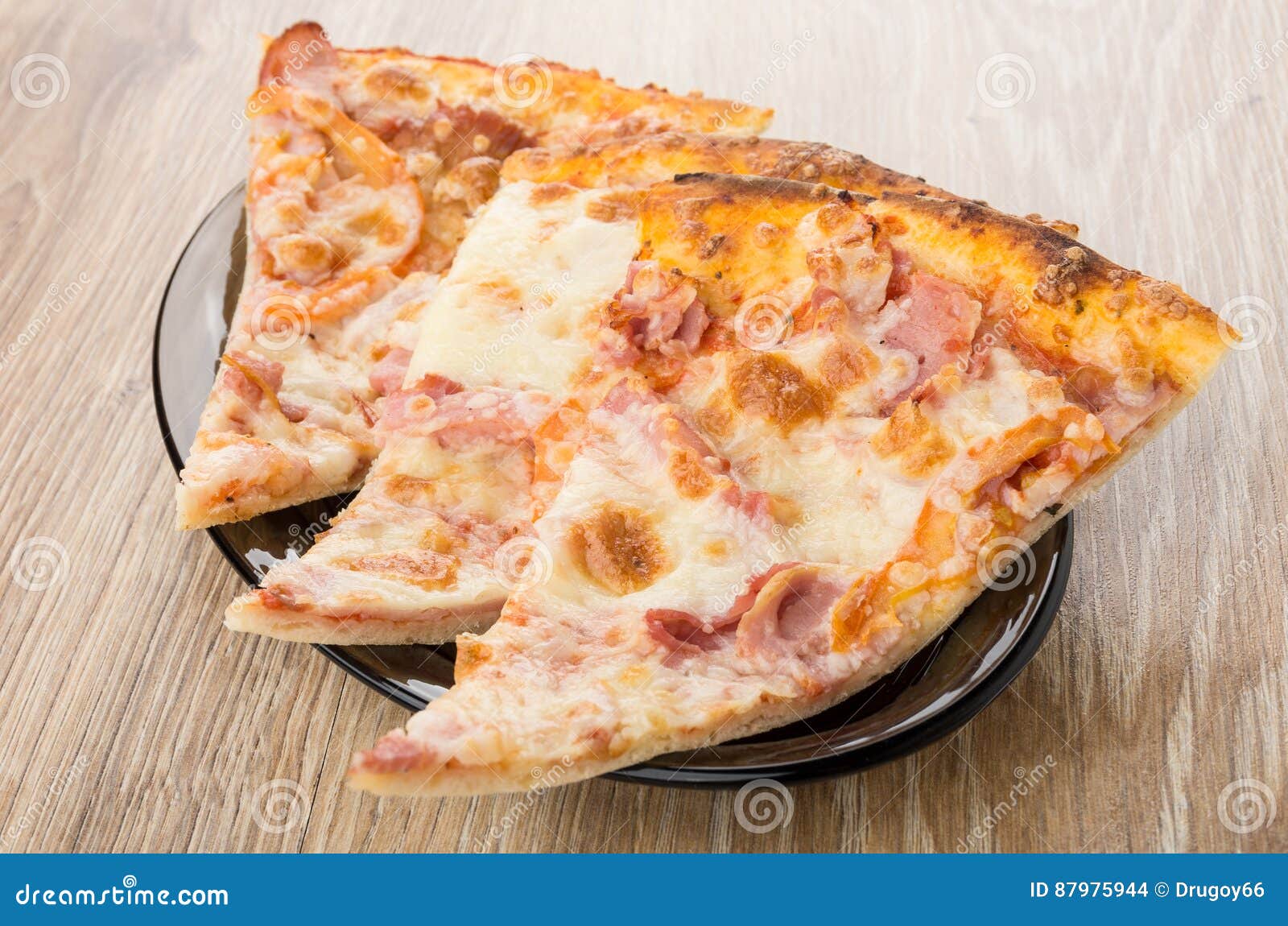 Three Pieces of Pizza in Black Oval Dish on Table Stock Photo - Image ...