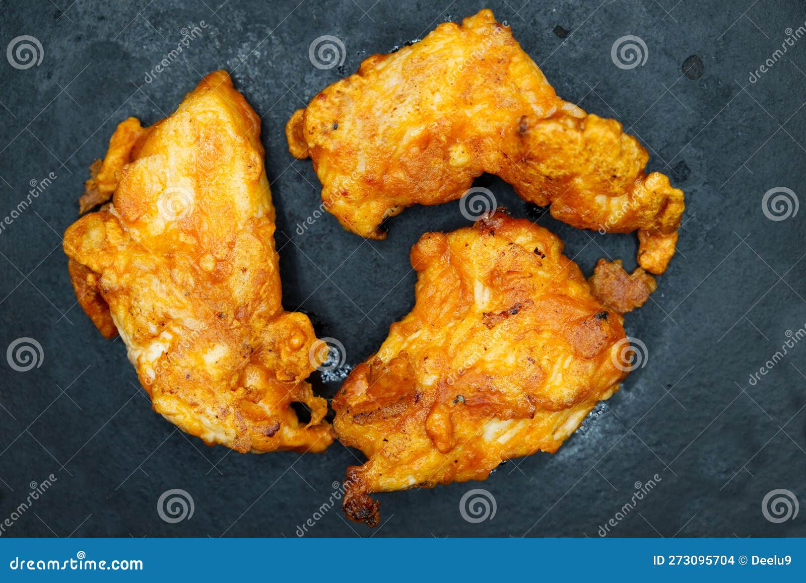 Three Pieces of White Meat Fried in Batter on Cast Iron Frying Pan ...