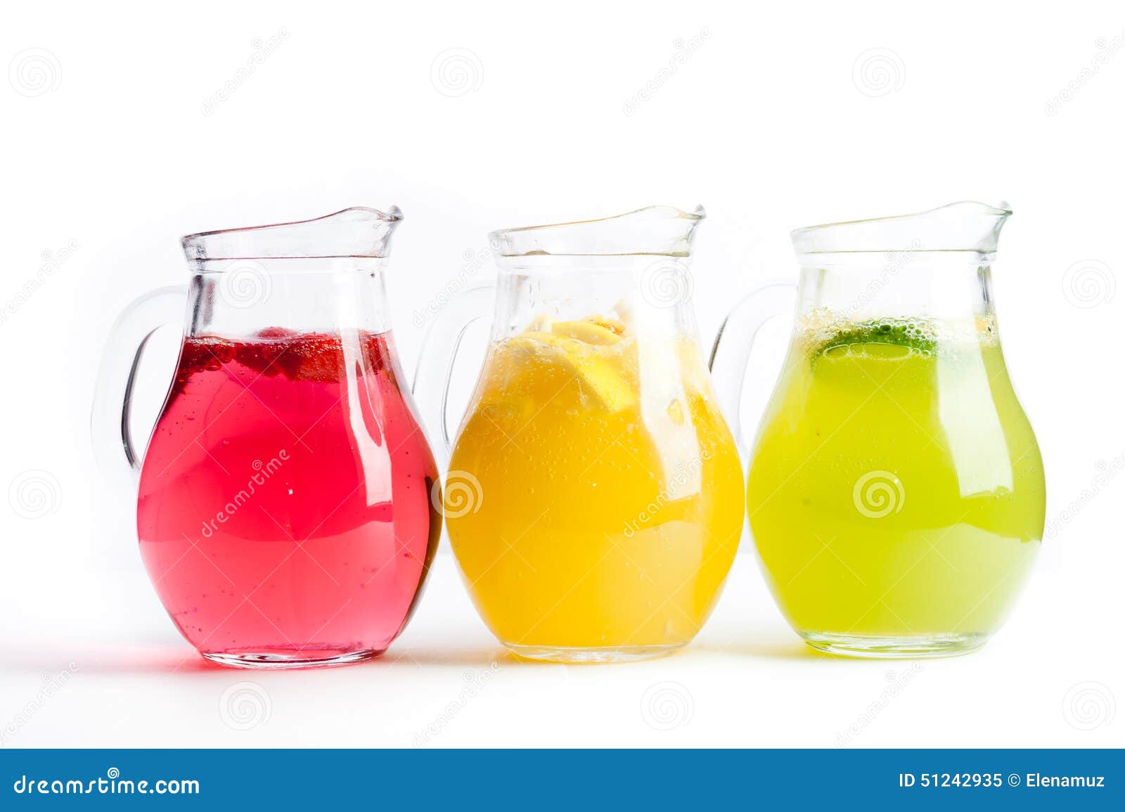 Three Pitchers with Red, Yellow, Green Fruit Juice on a White Ba Stock ...