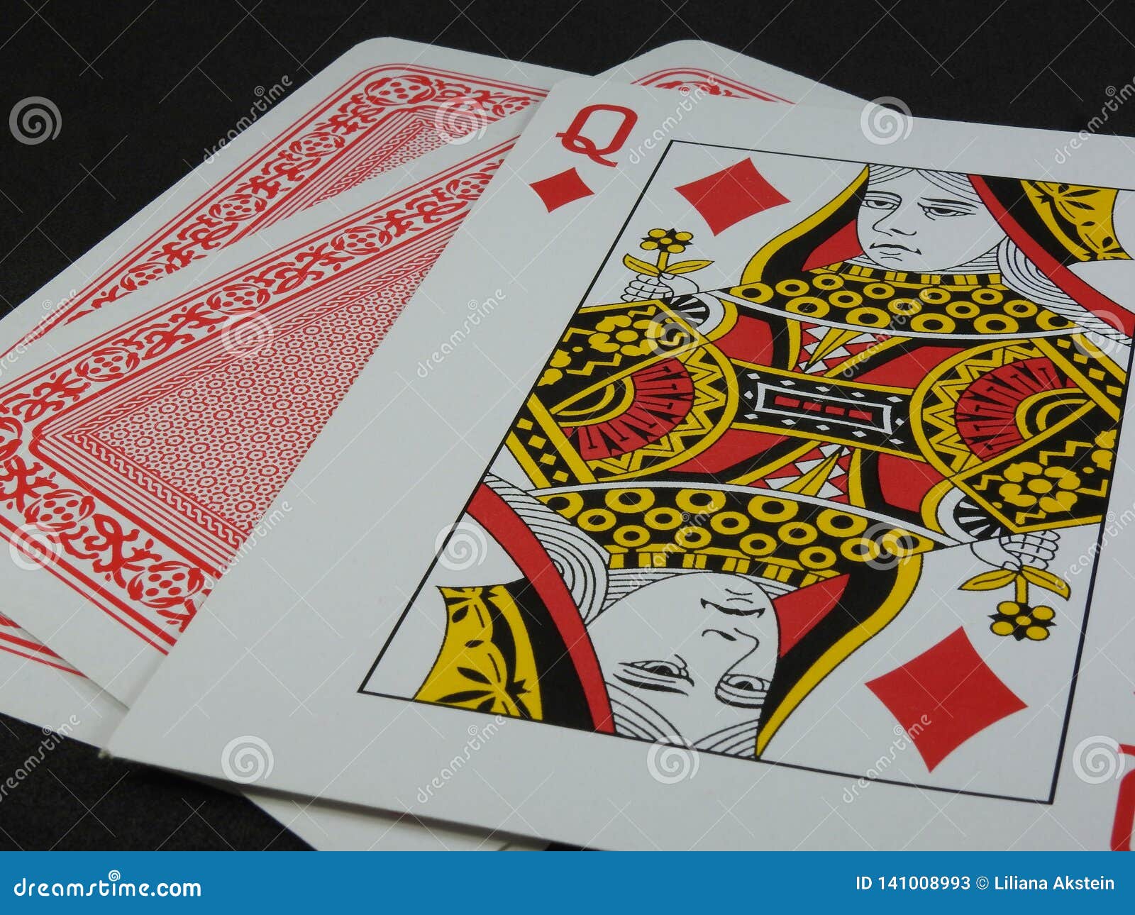 Three Playing Cards. the Queen of Diamonds is Facing Up. Stock Image ...