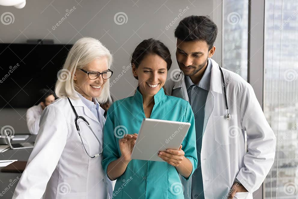Three Positive Smiling Medical Professionals Using Tablet Stock Image ...