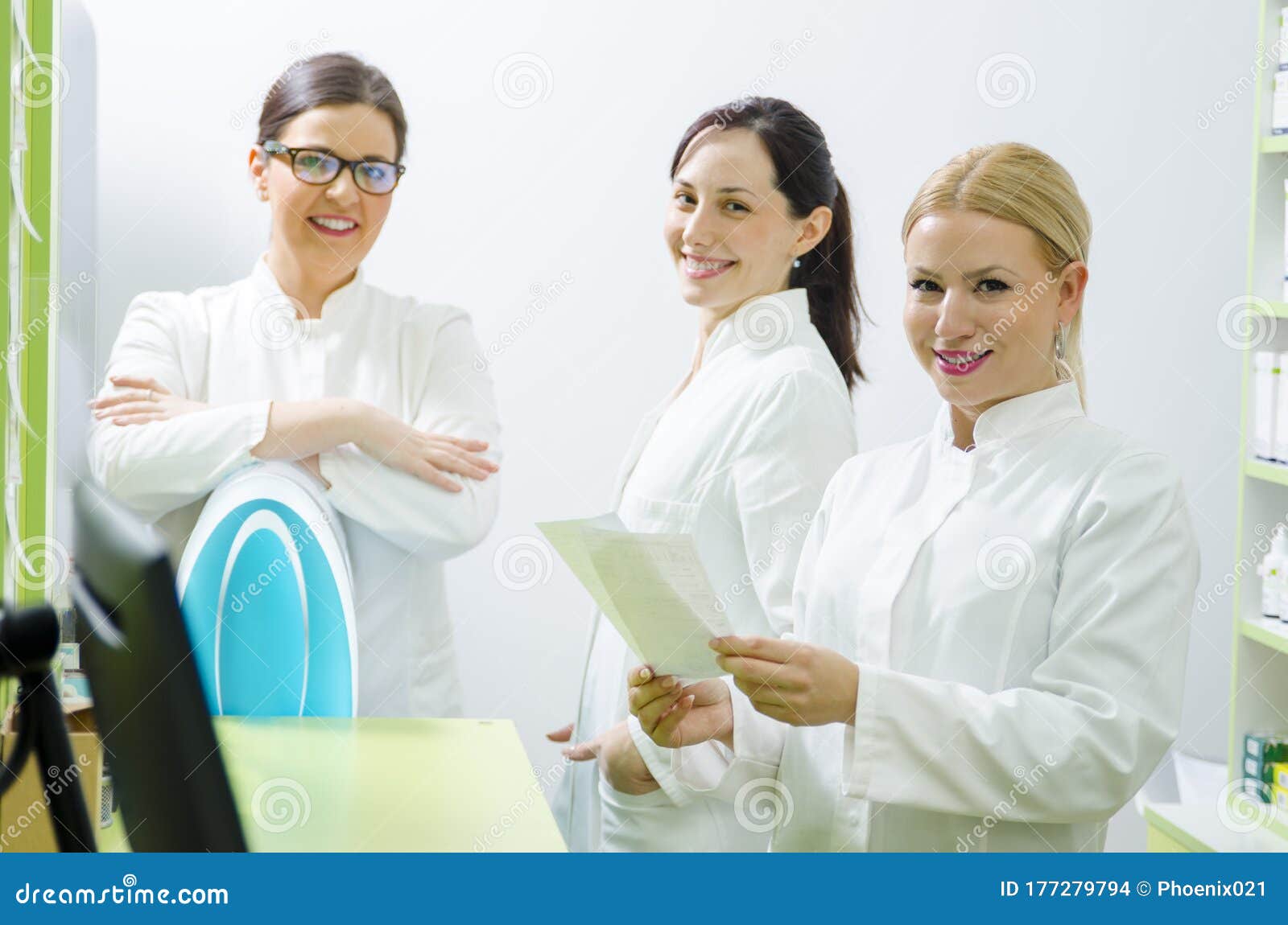 Three Pretty Female Pharmacists at Work Posing Stock Photo - Image of ...