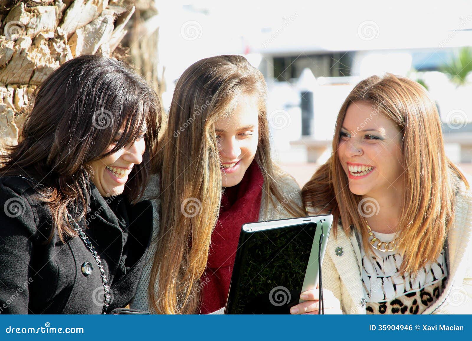Three Pretty Friends Enjoying with a Tablet. Stock Photo - Image of ...