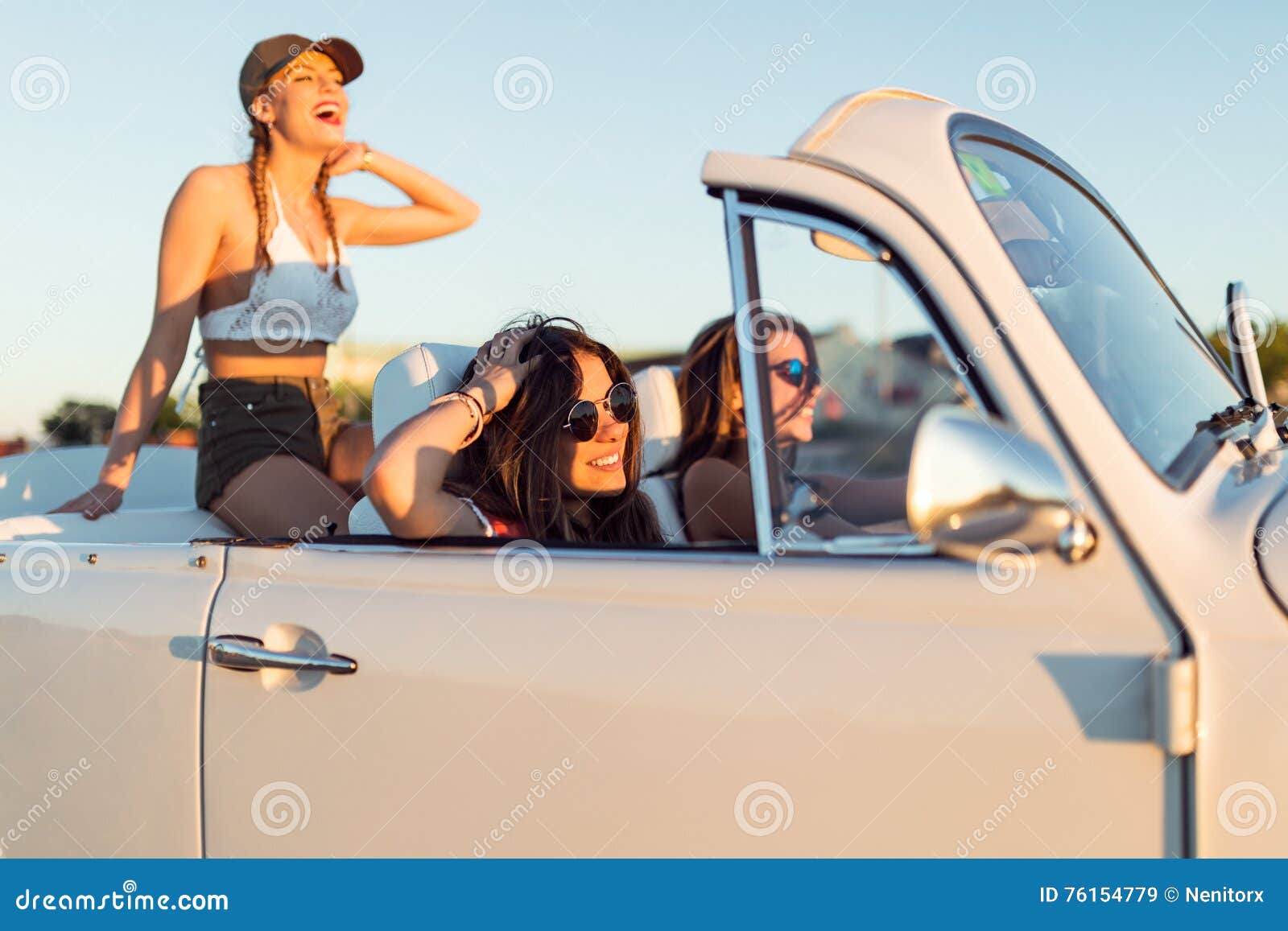 Three Pretty Young Women Driving On Road Trip On Beautiful Summe Stock