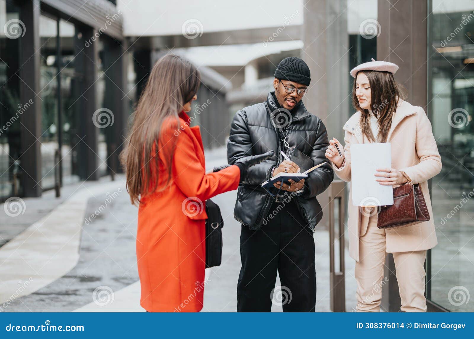 Three Professionals Engaged in a Conversation Outside Modern Office ...