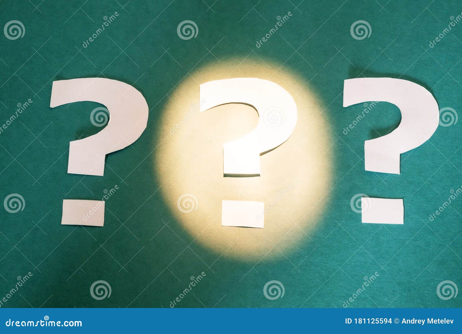 Three Question Marks Cut Out of Paper are on a Paper Background Stock ...