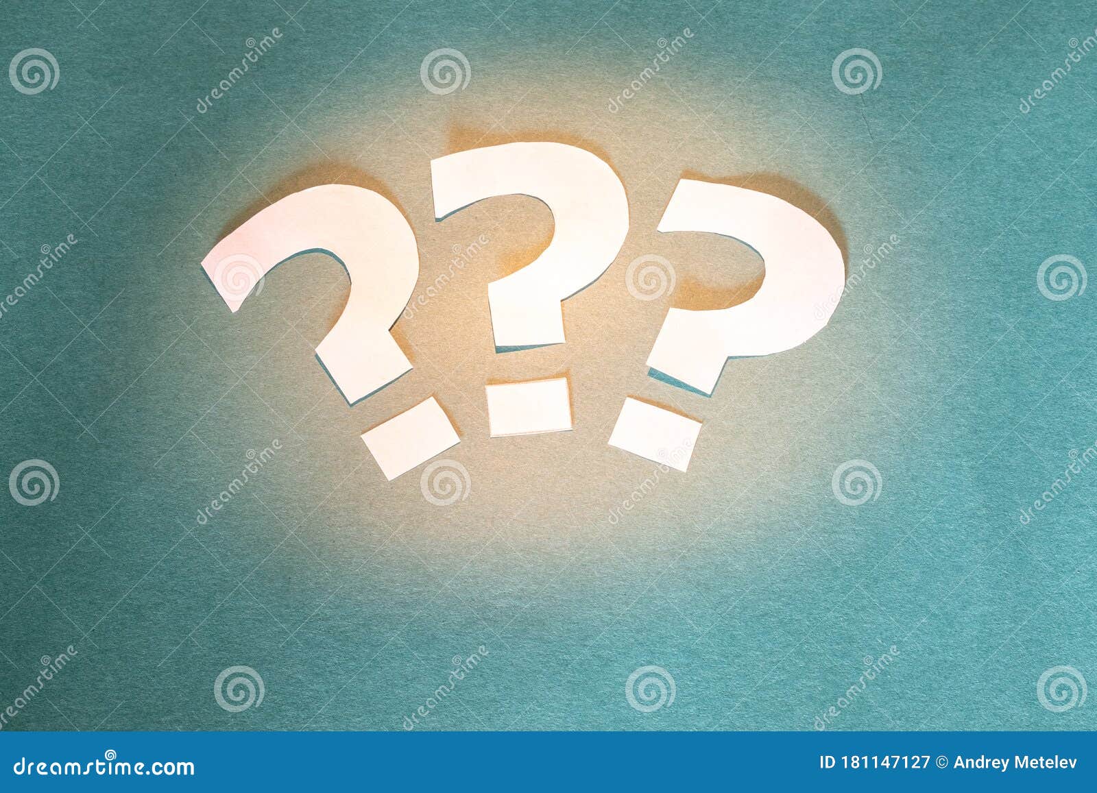 Three Question Marks Cut Out of Paper on a Paper Texture Background ...