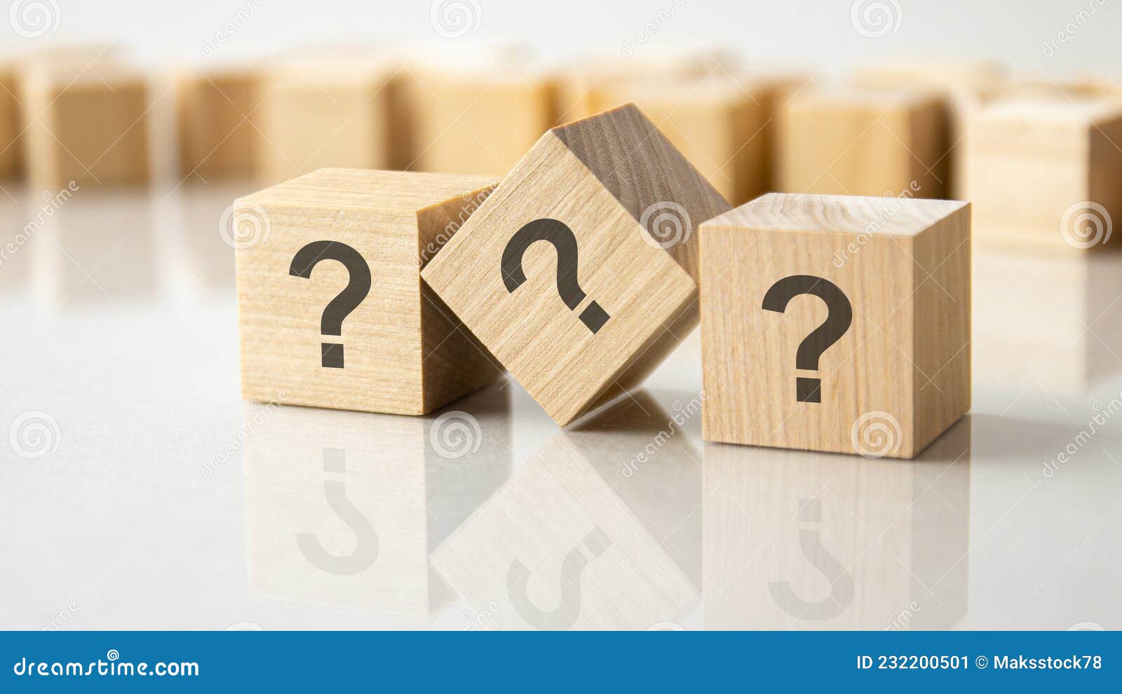 Three Question Marks Written on Wooden Cubes, Lying on the Gray Table ...