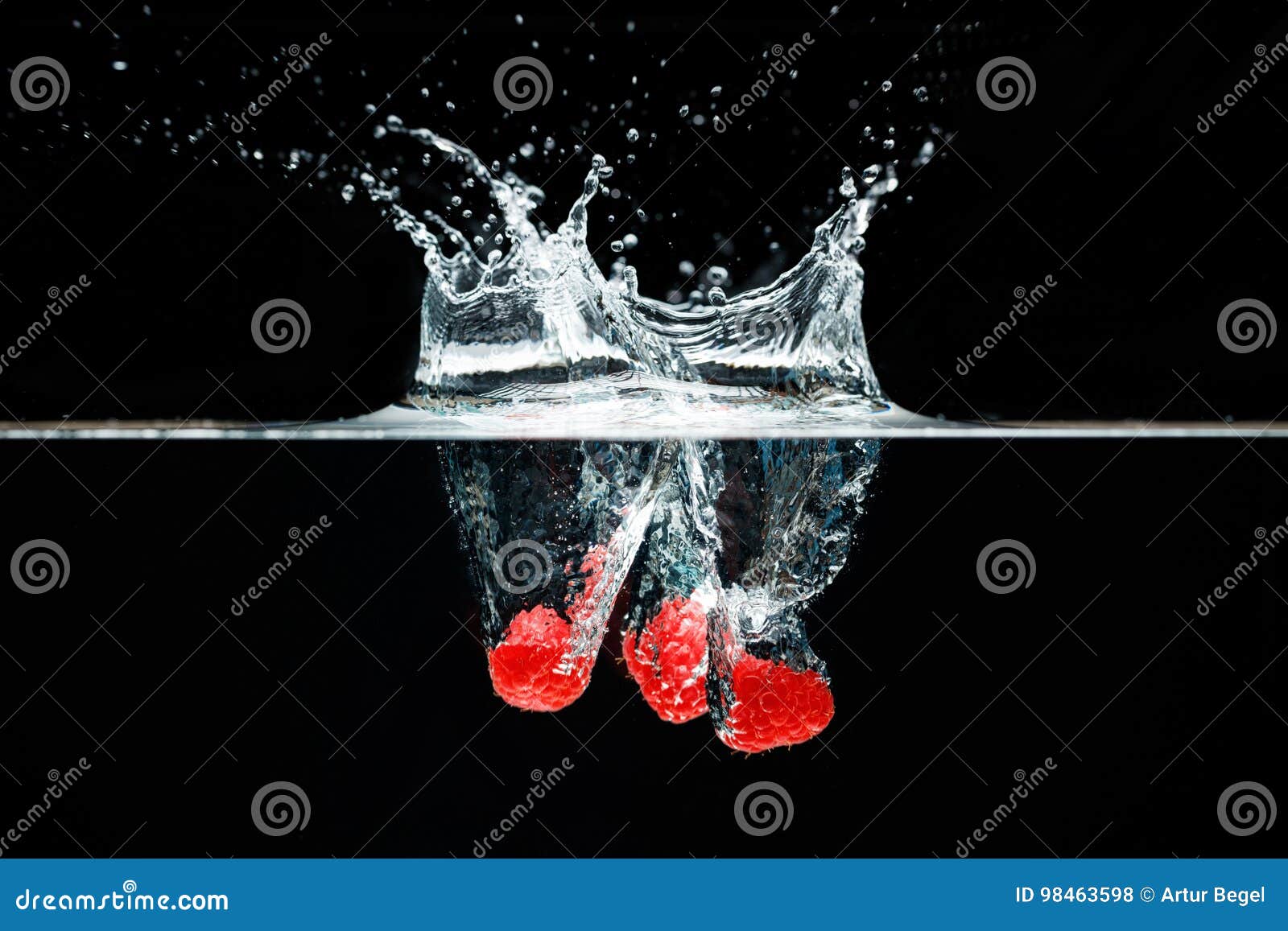 Three Raspberrys Falls Deeply Under Water with a Big Splash. Stock ...