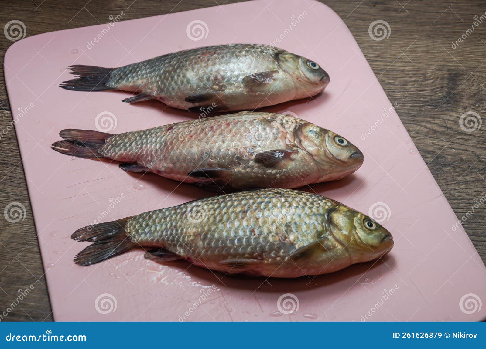 Three Raw Crucian Fish on a Cutting Board Stock Image - Image of ...