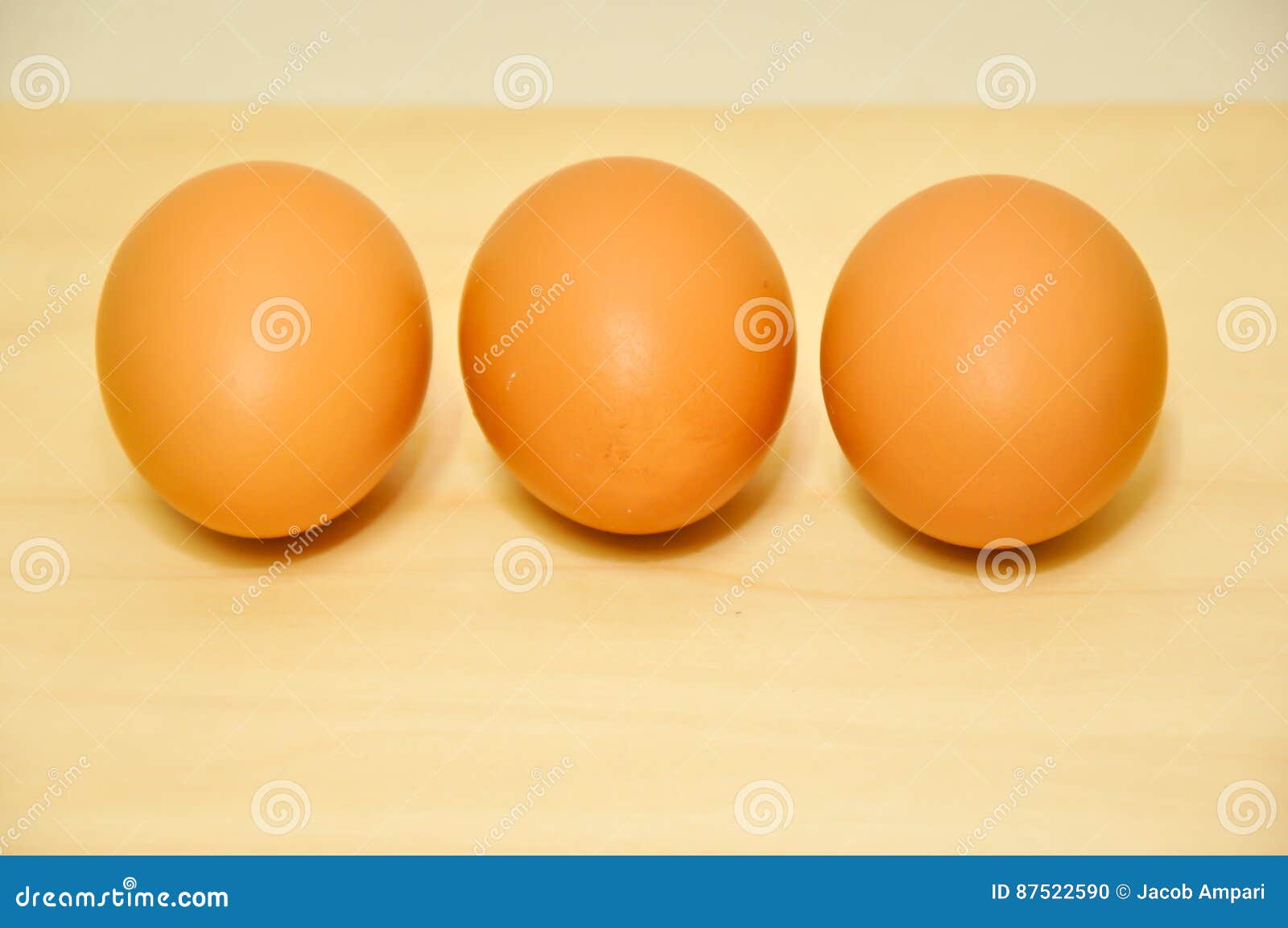 Three raw egg in a row stock photo. Image of chicken - 87522590