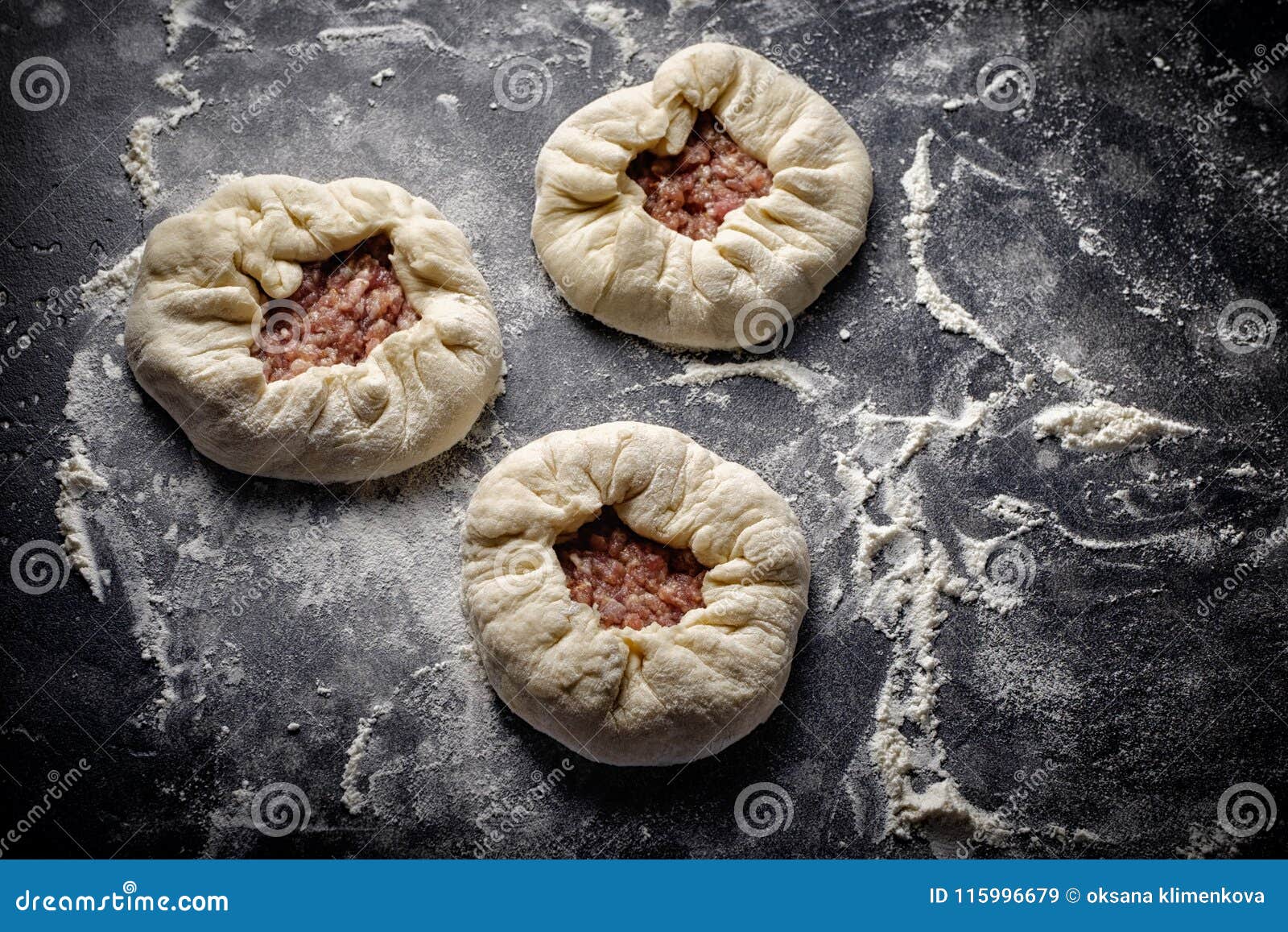 Three Raw Pies with Fresh Meat on Black Surfaces Covered with Flour ...