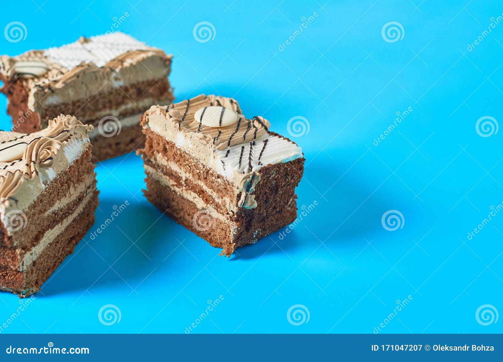 Three Rectangular Pieces of Cake Lies on Blue Table on Party ...