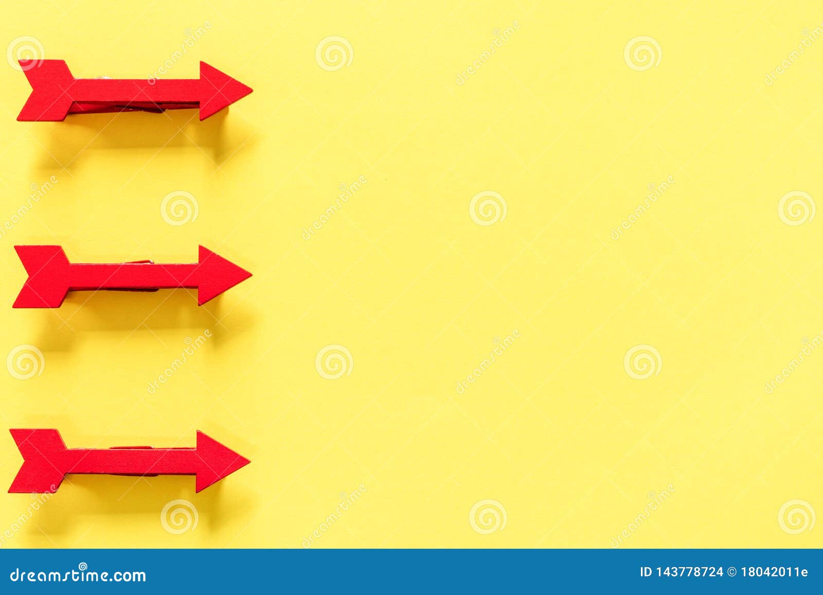 Three Red Arrow on Bright Yellow Background, Top View Stock Photo ...