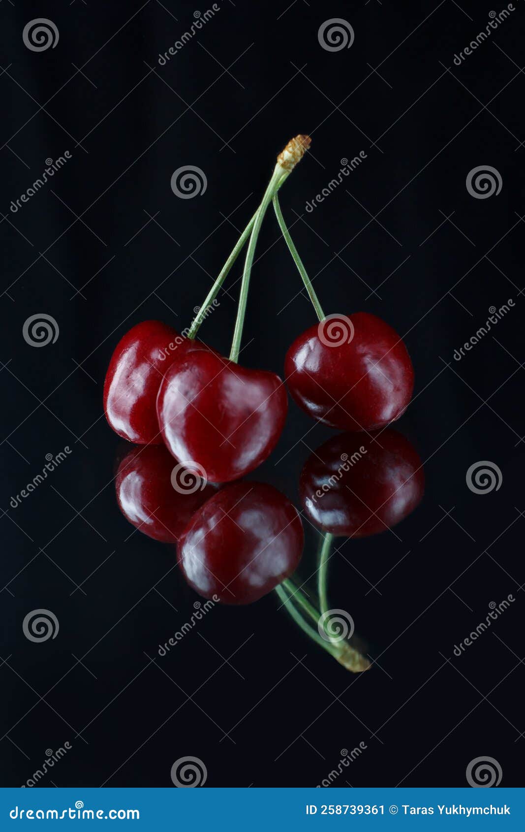 Three Red Cherries on a Black Background with Reflection. Fresh ...