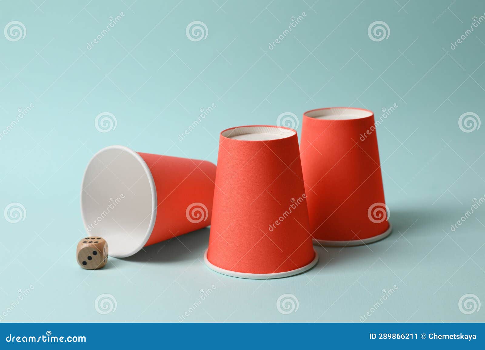Three Red Cups and Dice on Light Blue Background. Thimblerig Game Stock ...