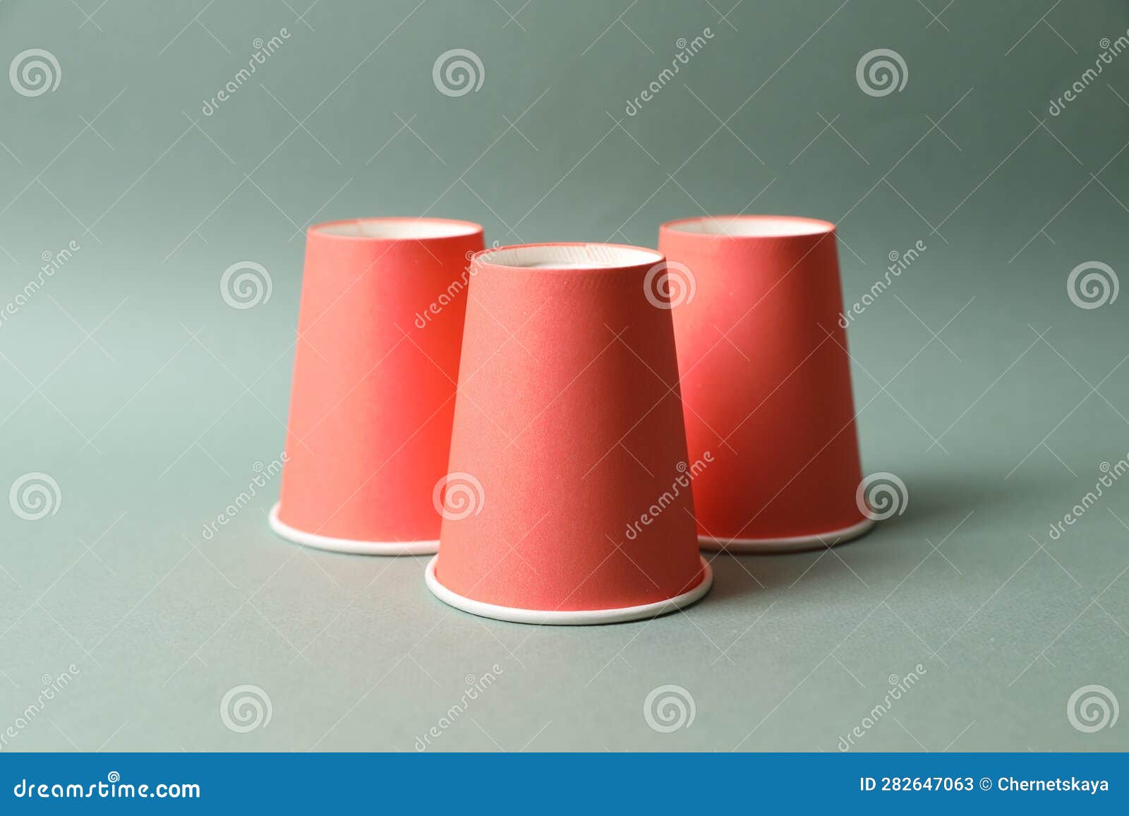 Three Red Cups on Pale Olive Background. Thimblerig Game Stock Image ...