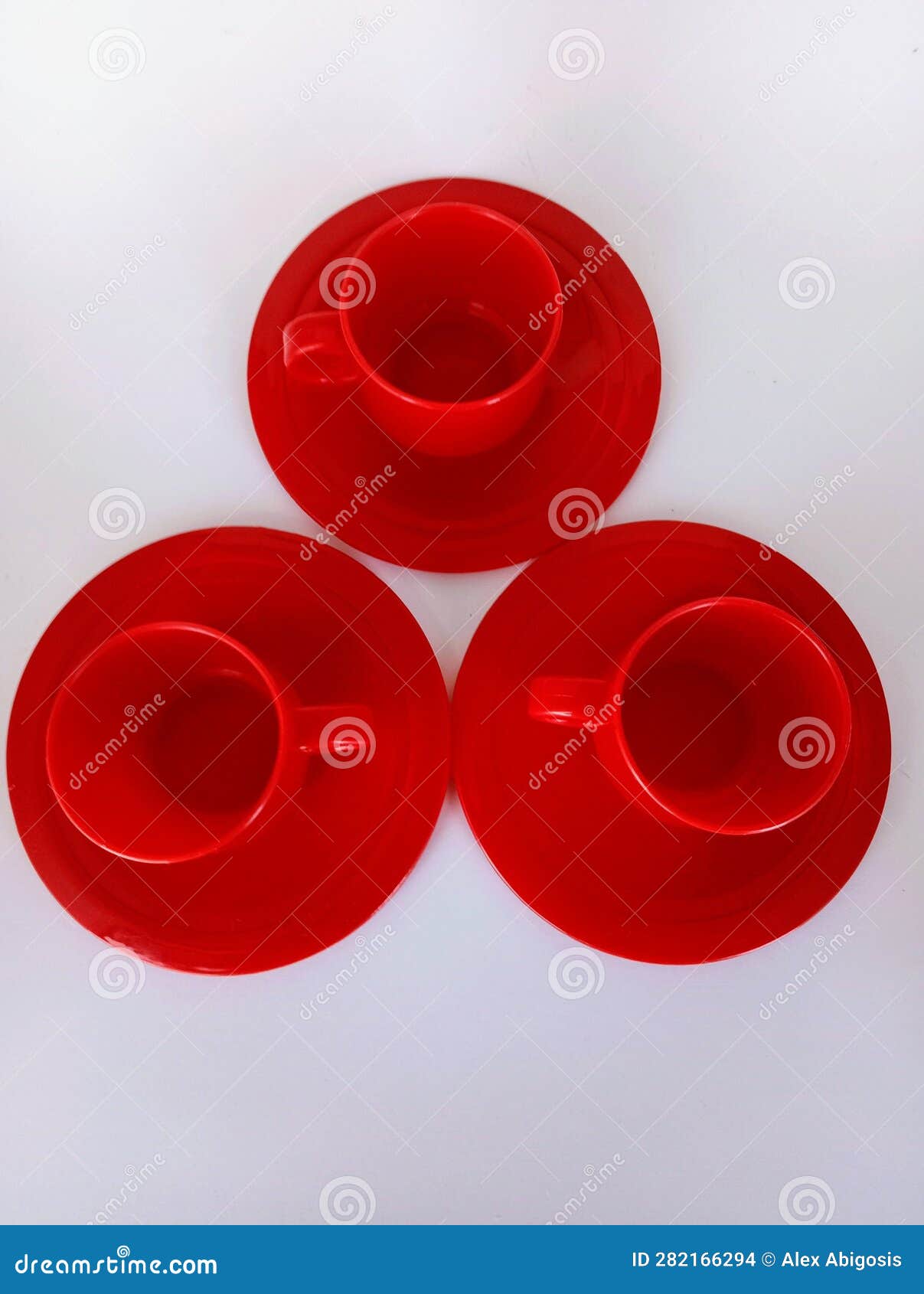 Three Red Cups and Saucers Arranged on a White Background from Above ...
