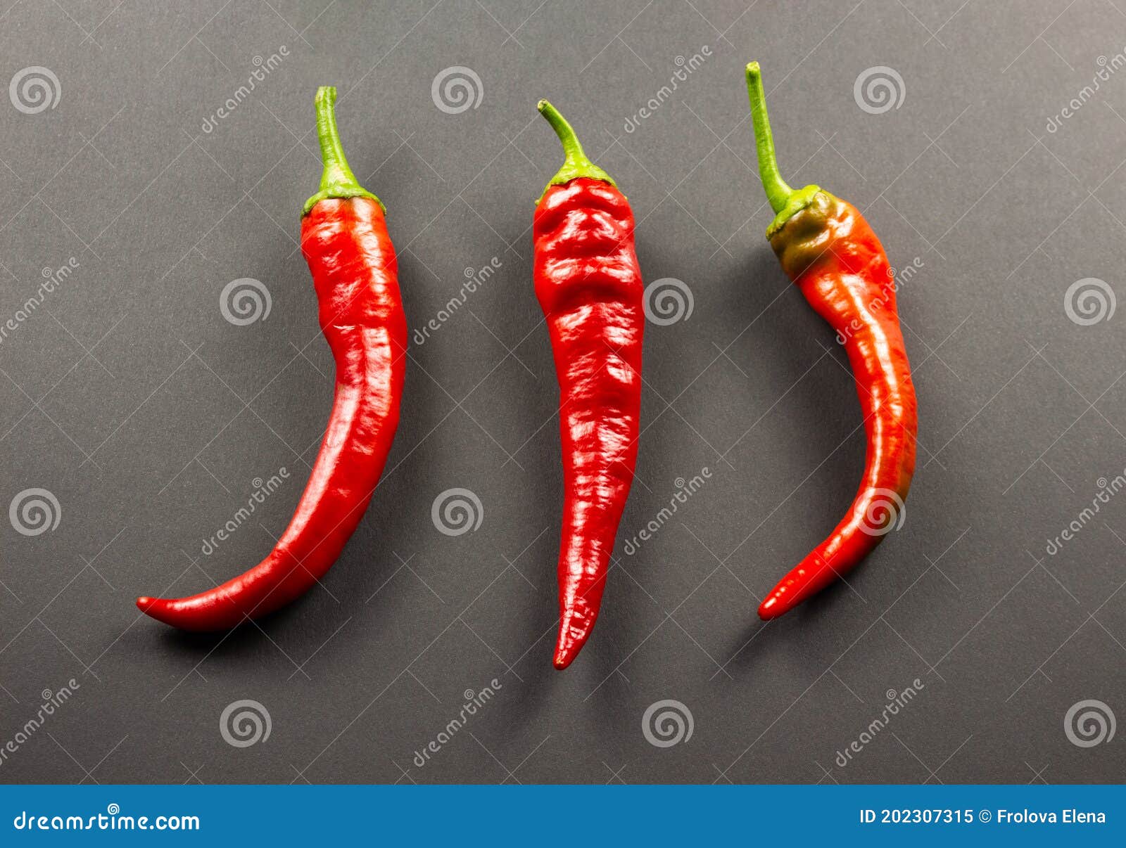 Three Red Peppers on a Dark Background, Close-up Stock Image - Image of ...