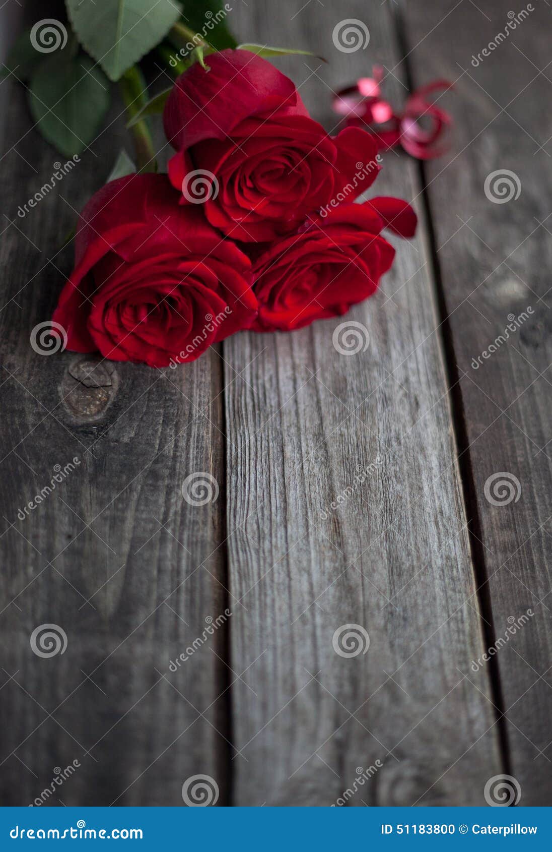 Three Red Roses on Rustic Table Stock Photo - Image of event, birthday ...