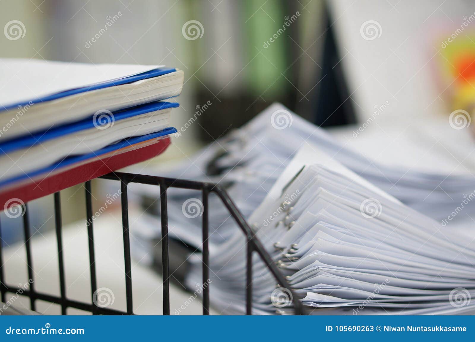 Three of Report Notebook on Black Shelf Rack and Pile of White Data ...