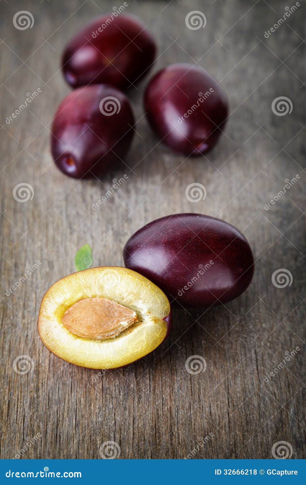 Three Ripe Plums with Leaves Stock Photo - Image of purple, organic ...