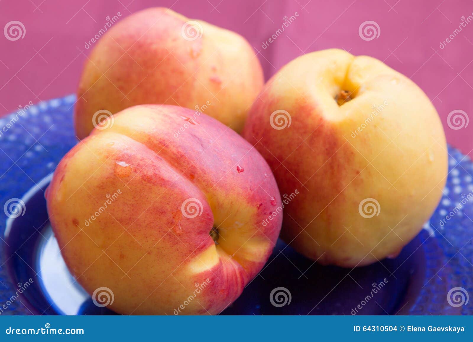 Three Ripe Red and Yellow Nectarine Lying on the Blue Plate. Stock ...