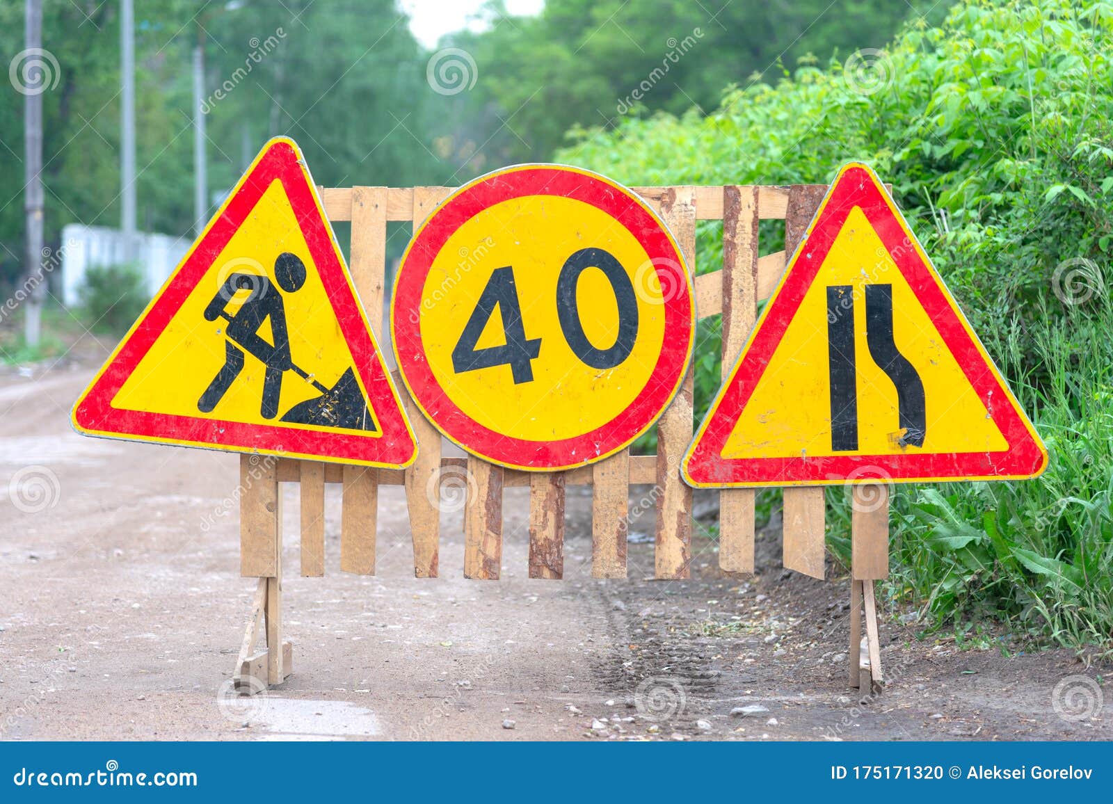 Three Road Signs Speed Limit And Speed Bump On An Iron Pole Royalty ...