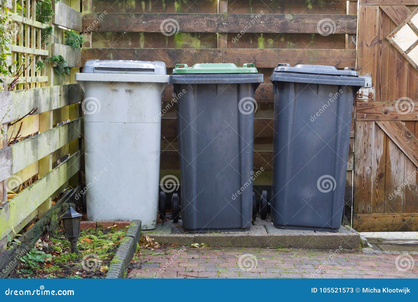 Three Rolling Trash Cans in a Dutch Garden Stock Image - Image of blue ...
