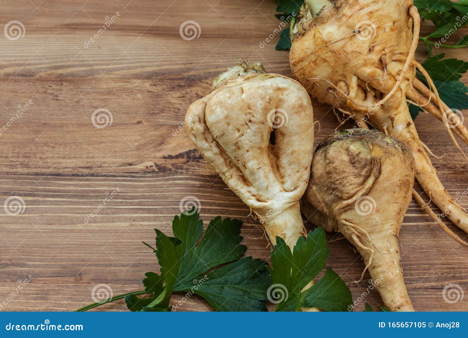 Three Root Crops of Parsnip on a Light Brown Wooden Surface, on the ...