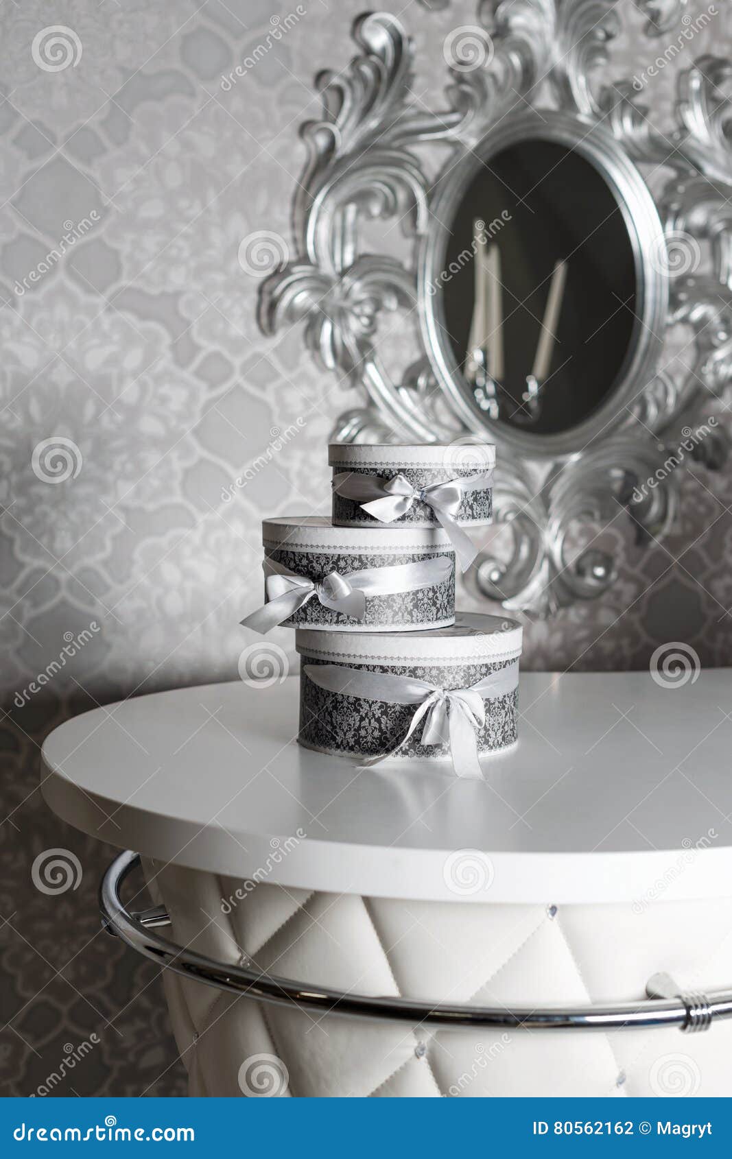 Three Round Celebration Gift Boxes with Silver Ribbon Bows on White ...