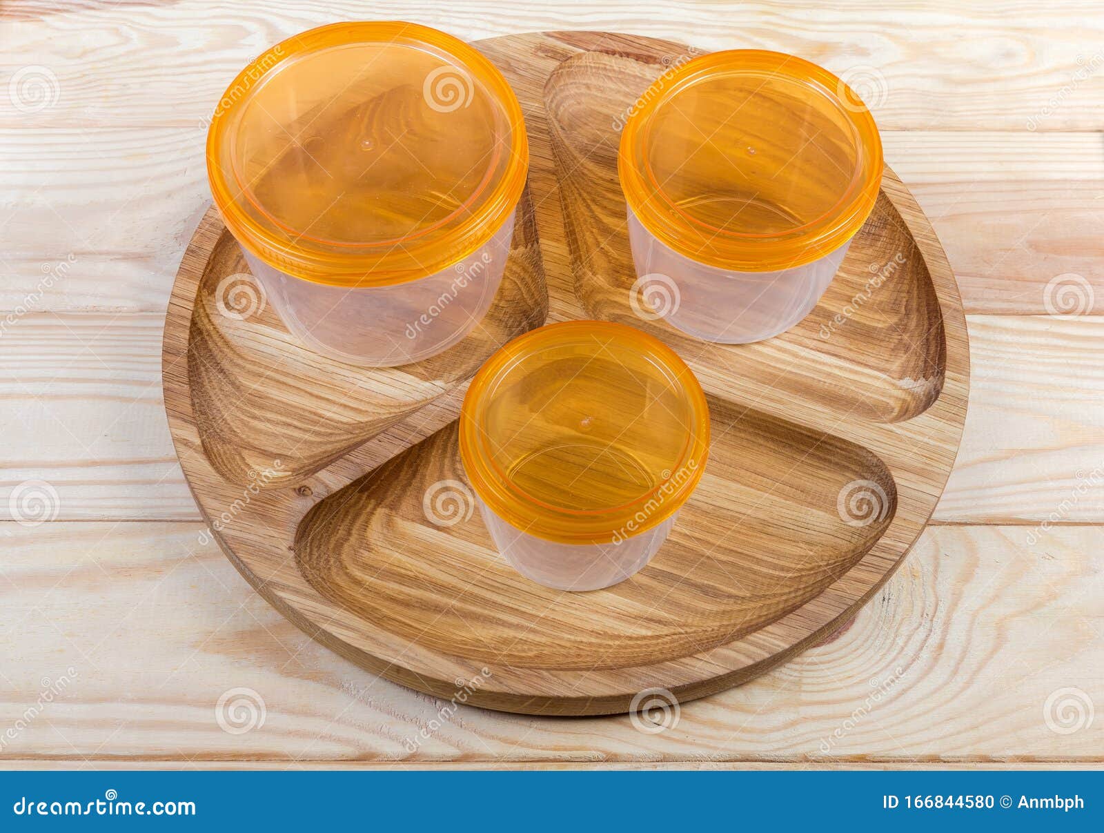 Three Round Plastic Food Storage Containers on Wooden Compartmental ...