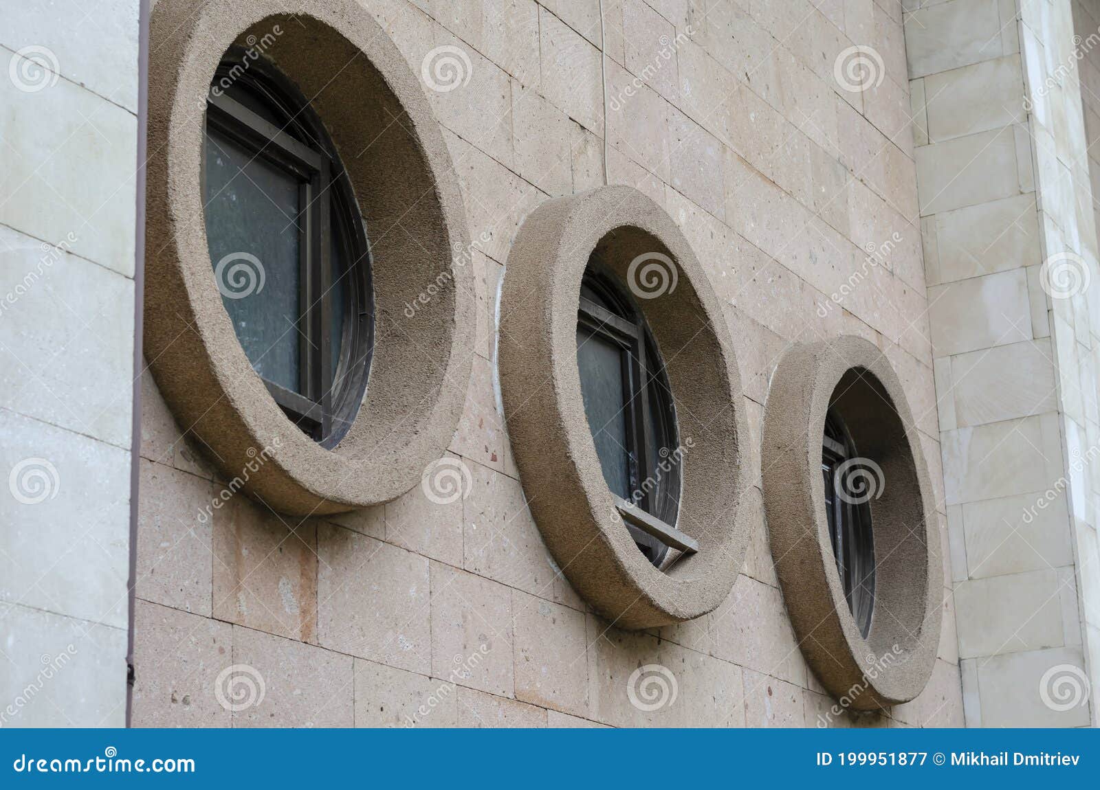 Three Round Windows with Square Window Frames Inside on Facade of Stone ...