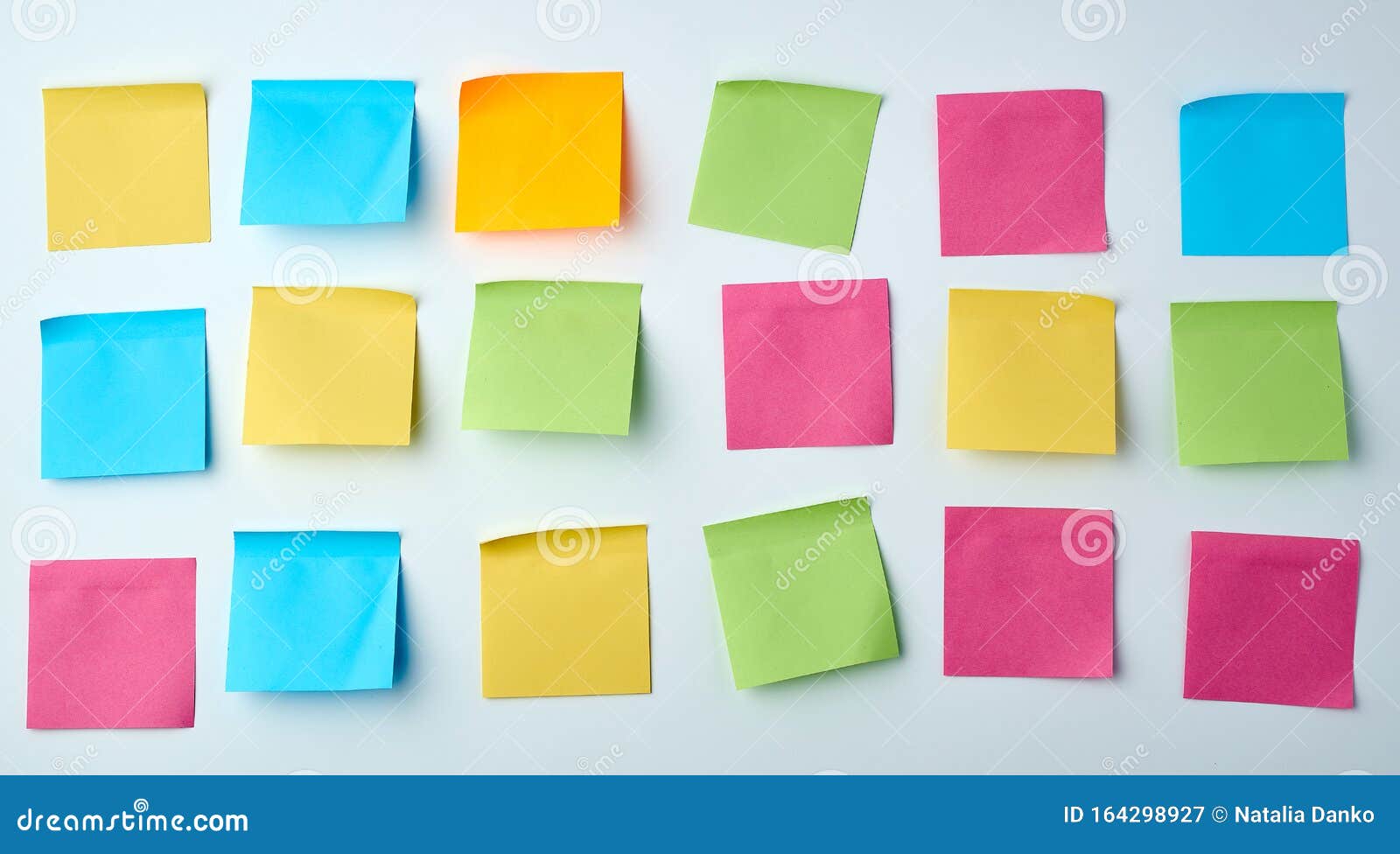 Three Rows of Blank Square Paper Multicolored Stickers on a White Wall ...